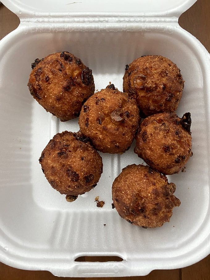 Hushpuppies golden and crisp as sunrise, waiting to silence hunger pangs with their cornmeal magic.