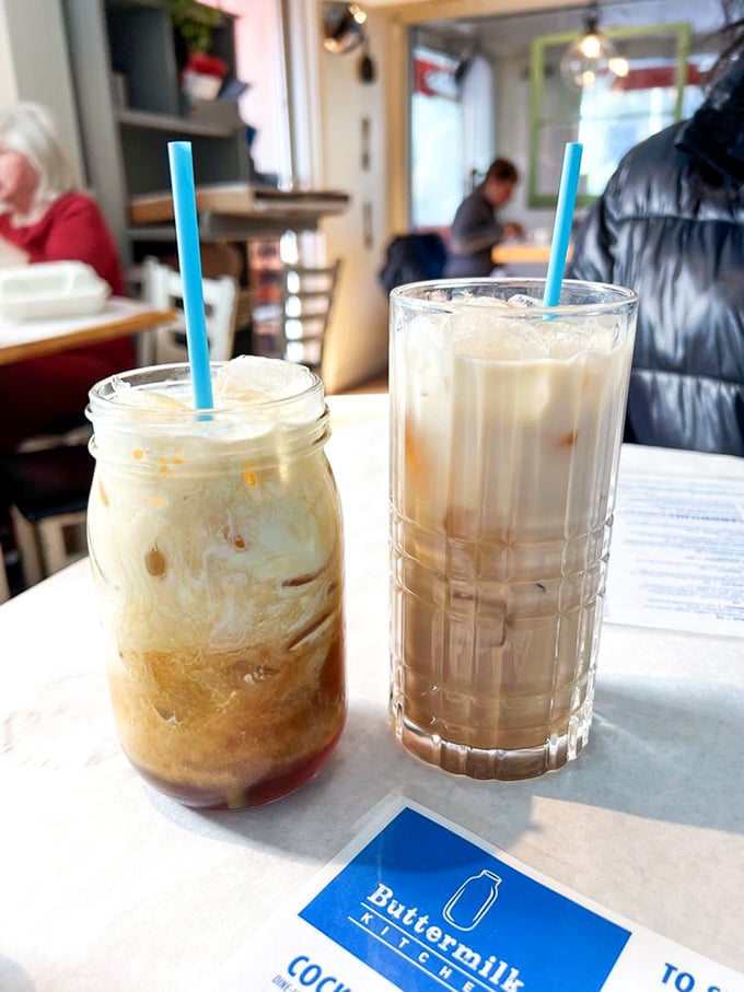 Coffee becomes art when served in mason jars with swirls of cream dancing through the brew—morning fuel that's as beautiful as it is necessary.