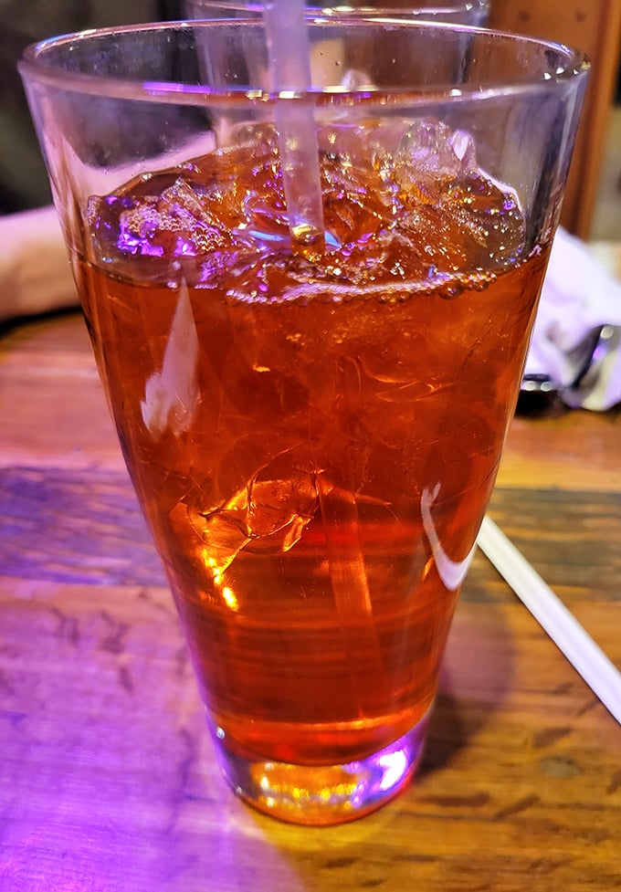 The Thai iced tea glows with amber promise—sweet, strong, and the perfect firefighter for taste buds that ventured too far into spice territory.
