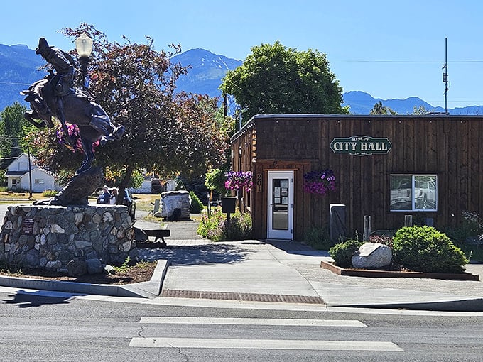 City Hall that looks like it belongs in a Western—complete with bronze rider. Small town governance with big personality.