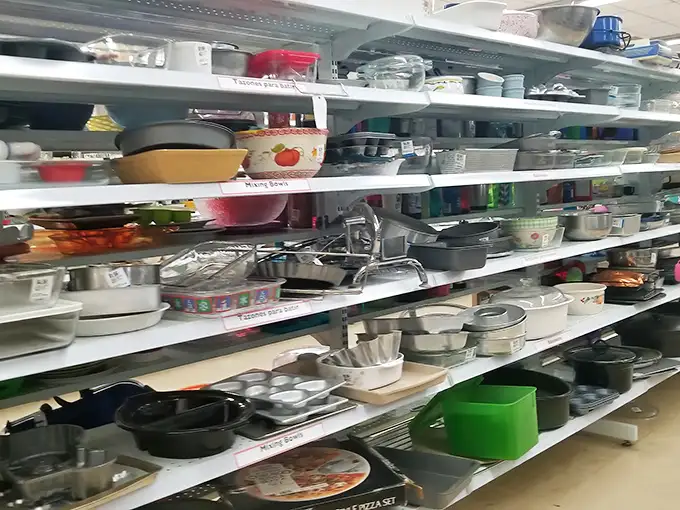 Kitchenware paradise where cast iron pans with decades of seasoning sit alongside barely-used wedding registry items from abandoned cooking phases.