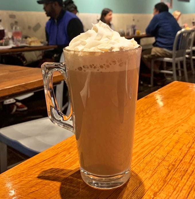That's not just a latte—it's a frothy tower of caffeinated bliss, topped with enough whipped cream to make Monday mornings bearable.