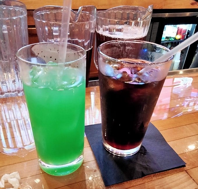 Even the drinks at Sweet P's bring the drama—this electric green concoction and classic cola offering visual proof that refreshment comes in all colors.