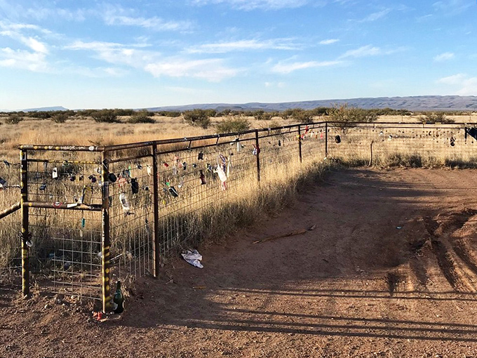 The fence surrounding Prada Marfa has become its own art installation—a patchwork of mementos from visitors making their mark on this surreal landmark.