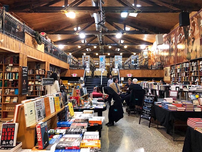 Tables laden with colorful spines create islands of possibility in a sea of literary treasures.