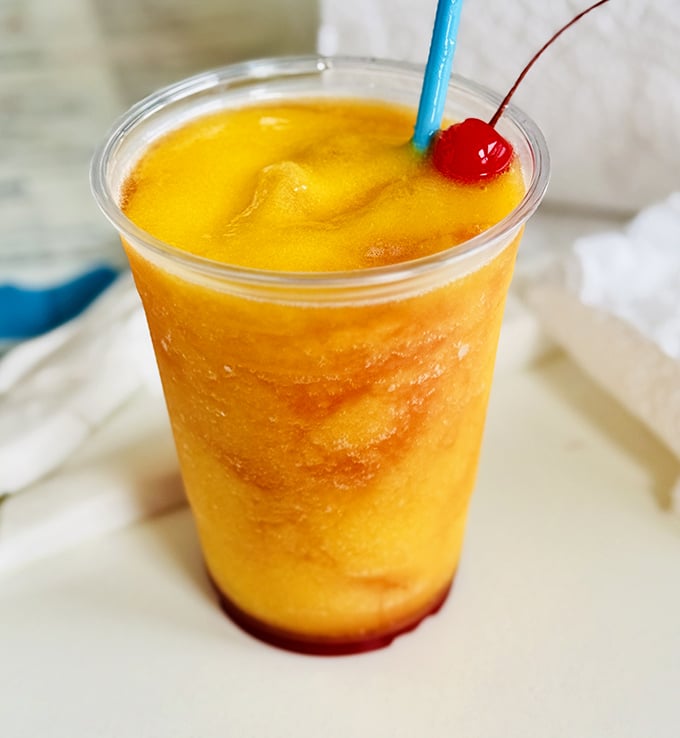 Sunshine in a glass with a cherry on top. This mango daiquiri doesn't just quench thirst—it tells time: it's officially vacation o'clock.