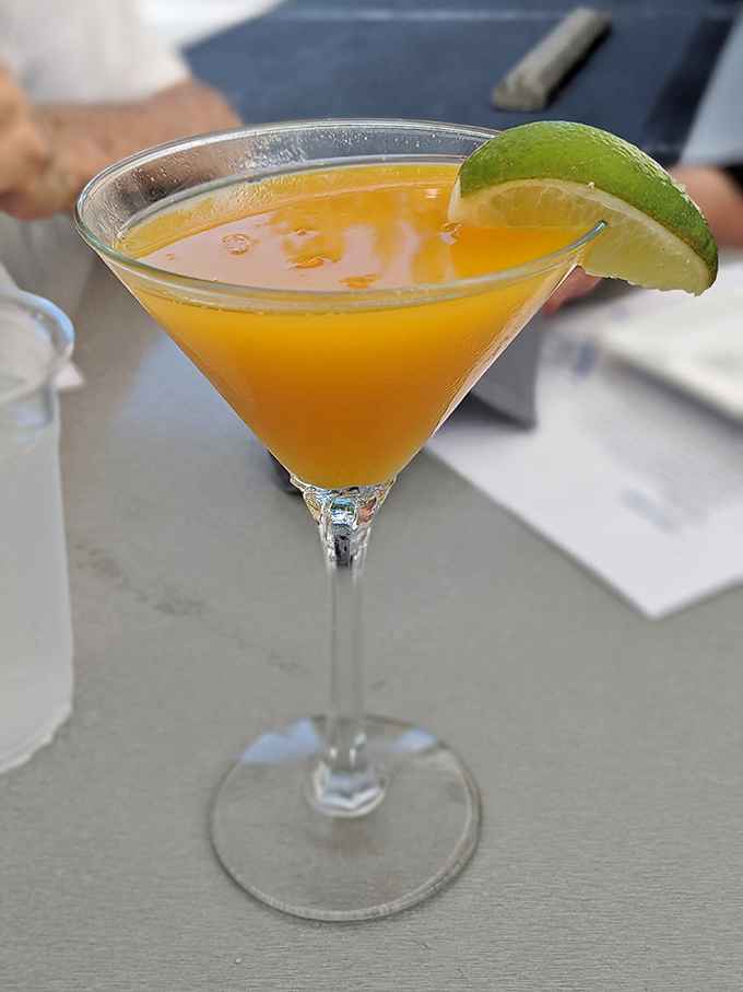 This isn't just a mango martini—it's liquid sunshine in a glass, with that lime wedge adding just the right amount of tropical sass.