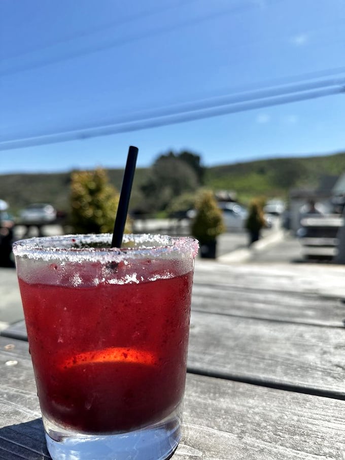 That crimson margarita with its salt-crusted rim sits like a California sunset in a glass, promising coastal relaxation with each sip.