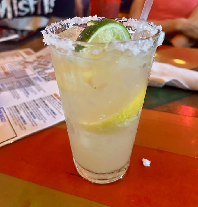 A proper margarita with salt-crusted rim and fresh lime—the kind that makes you forget about your mortgage and remember why you moved to Florida.