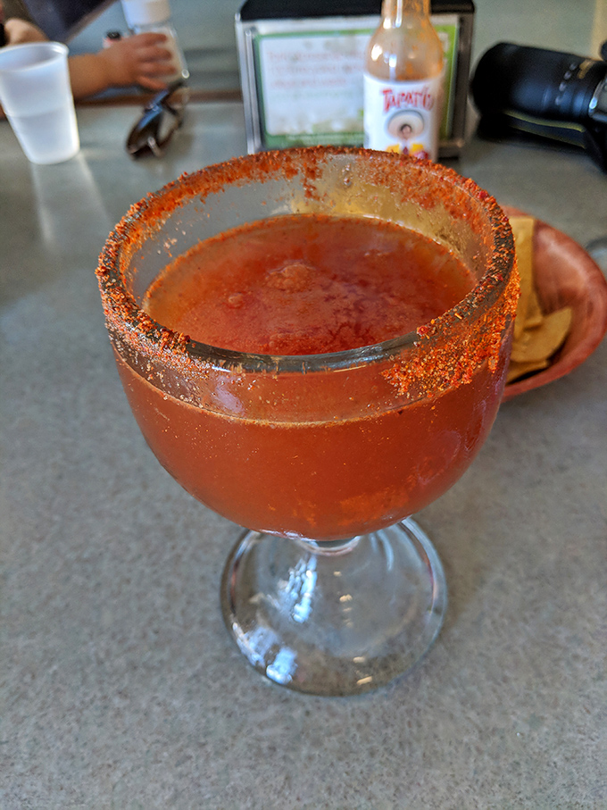 This isn't just a michelada—it's a spicy, savory cocktail experience with that chile-salt rim promising to wake up every taste bud you own.