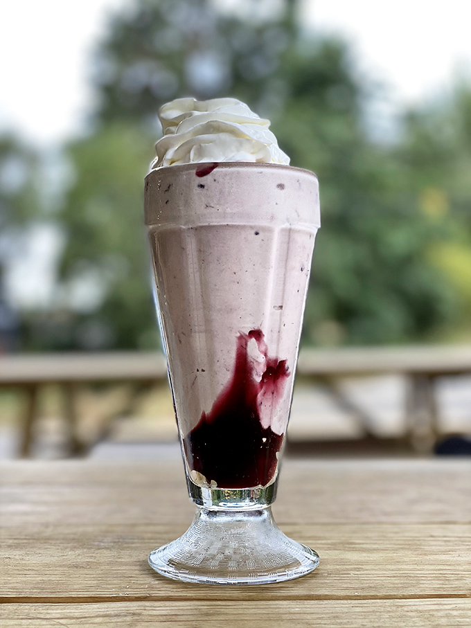 This isn't just a milkshake—it's a tower of creamy indulgence with berry swirls that make you question why you ever settled for anything less.
