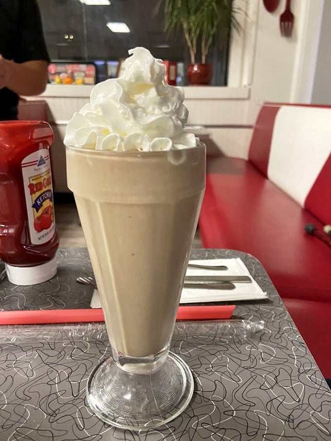 This isn't just a milkshake – it's a tower of creamy nostalgia topped with a cloud of whipped cream that demands both a spoon and straw.