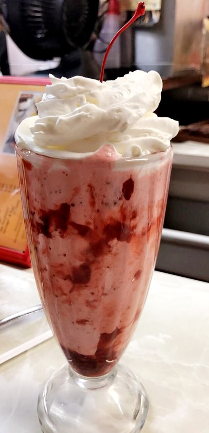 Not just a milkshake but a structural engineering marvel, where whipped cream defies gravity and cherry placement deserves an art degree.