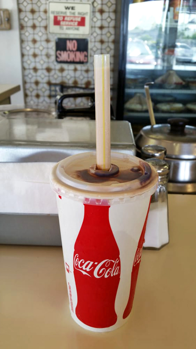 That classic Coca-Cola in a paper cup isn't just a drink—it's a time machine back to when simple pleasures were all we needed.
