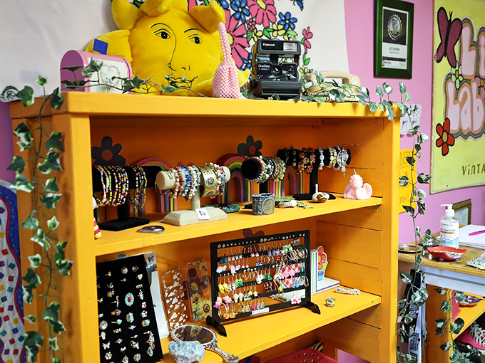 Jewelry heaven on a sunshine-yellow bookcase. That Polaroid camera isn't just decoration—it's waiting to capture your "found treasure" moment.
