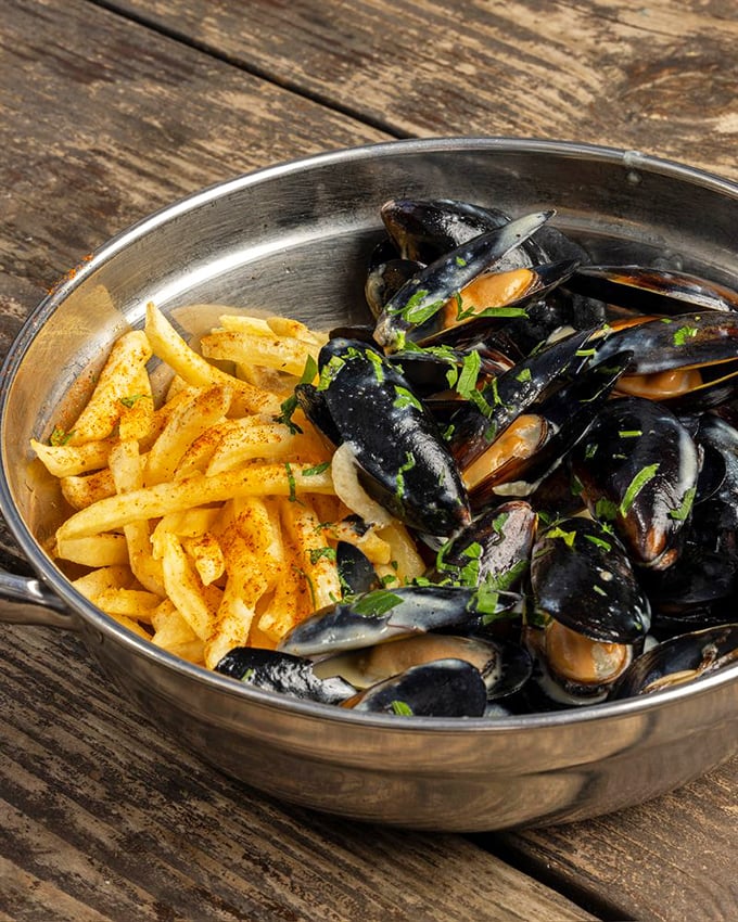 Mussels and fries—the Fred Astaire and Ginger Rogers of seafood pairings. They dance together in perfect harmony on your palate.