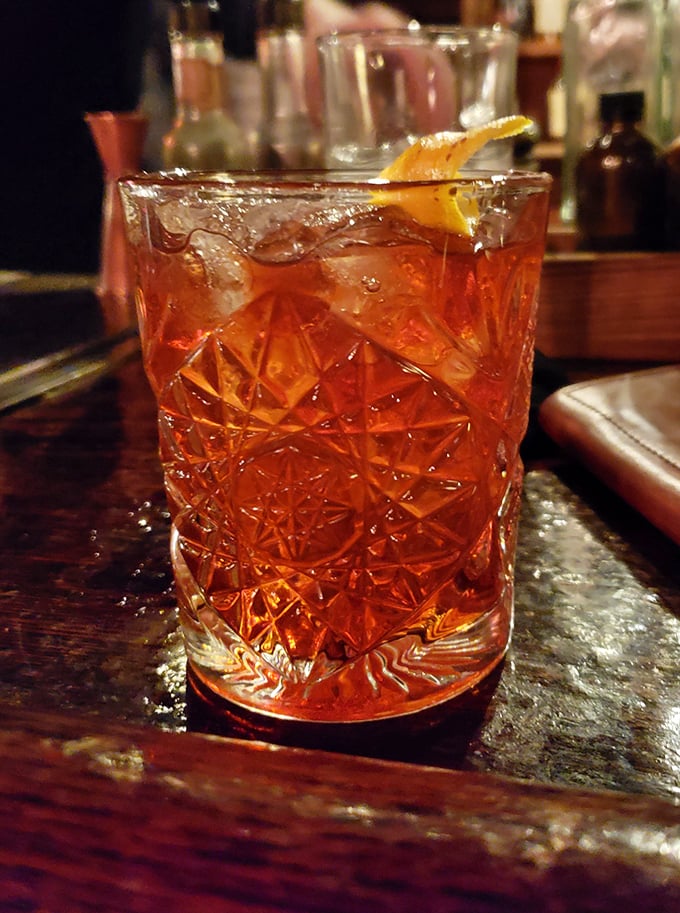 This isn't just a cocktail; it's liquid amber architecture in a glass that makes you wonder why you ever settled for a rum and coke.