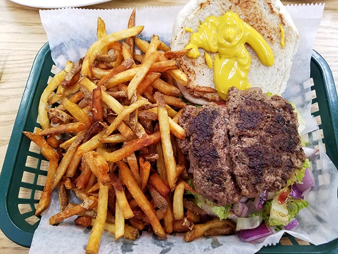 This burger comes with fries that could double as kindling – crispy, golden, and absolutely irresistible.
