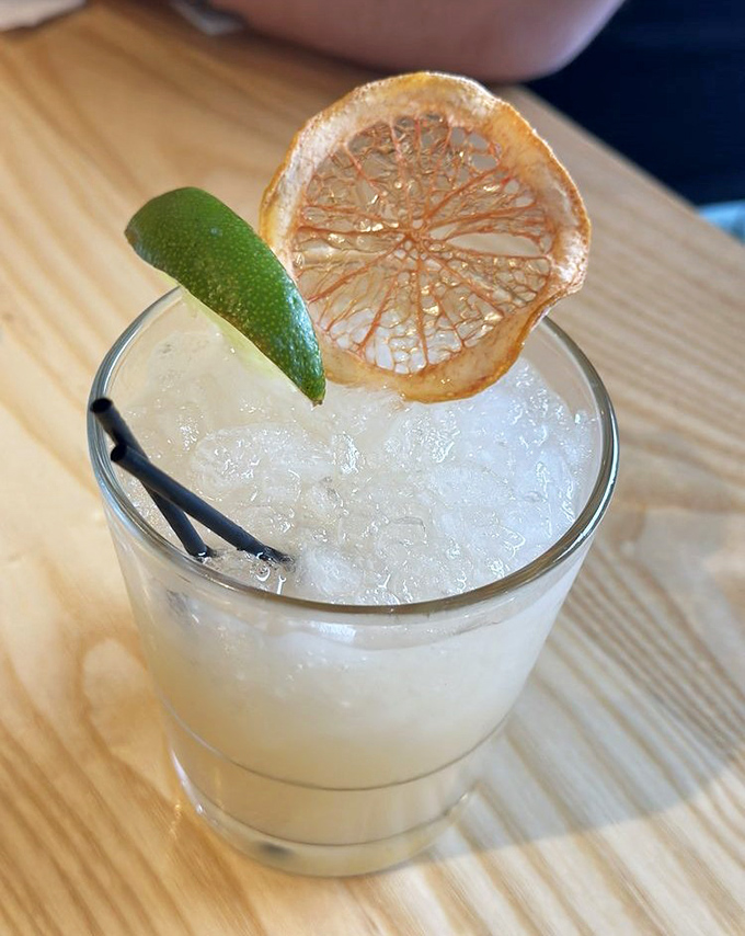 This cocktail isn't just a morning beverage—it's liquid sunshine with a dehydrated citrus halo that makes "it's 5 o'clock somewhere" completely irrelevant.