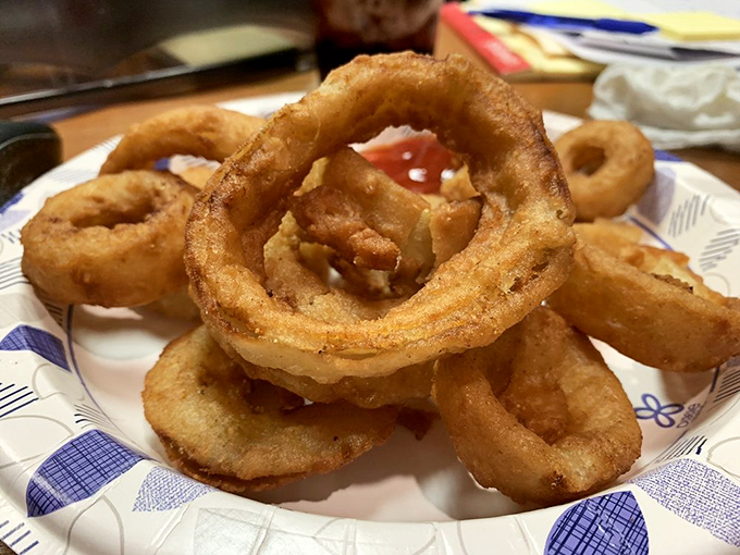 Golden, crispy onion rings with that perfect crunch-to-tender ratio—the supporting actor that sometimes steals the show from the burger stars.