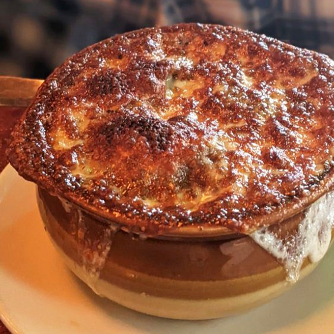 French onion soup with a cheese pull that deserves its own Instagram account—a bubbling cauldron of comfort that's worth the wait.