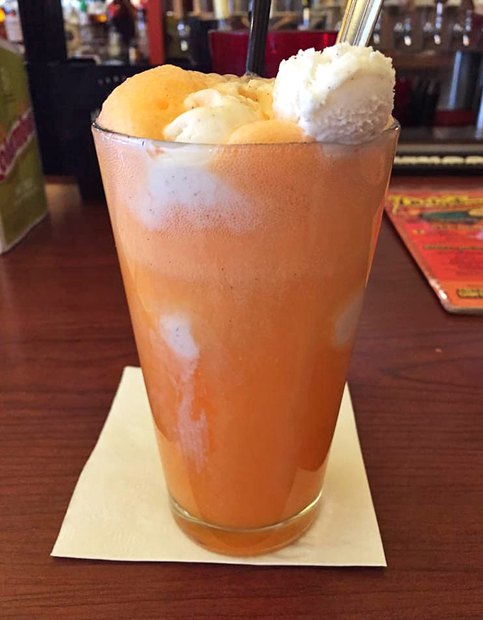This orange soda float isn't just a drink—it's childhood nostalgia served in a glass, topped with ice cream islands of pure joy.