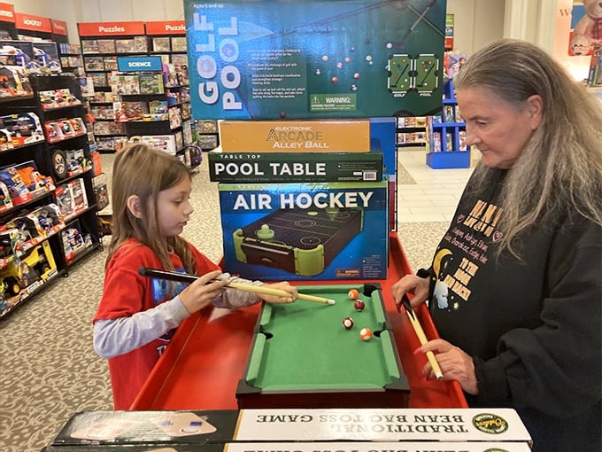 Generations connect over a miniature pool table, proving that the best shopping experiences sometimes aren't about what you buy, but who you're with.
