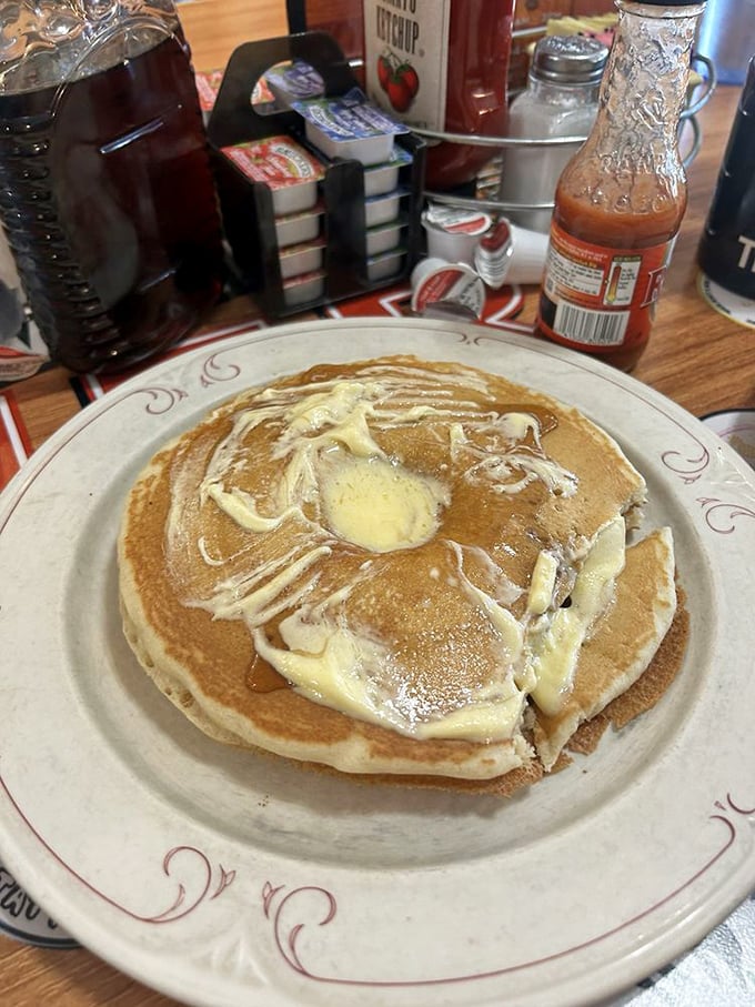 Pancakes stacked like fluffy clouds of happiness – these golden beauties redefine what hotcakes should taste like.