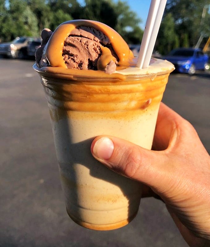 Peanut butter cascading over ice cream with chocolate accents – this shake isn't just a dessert, it's performance art in a cup.