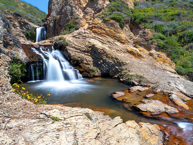 Water tumbles between ancient rock formations, creating pools that reflect California's impossibly blue skies – nature's infinity pool without the resort prices.