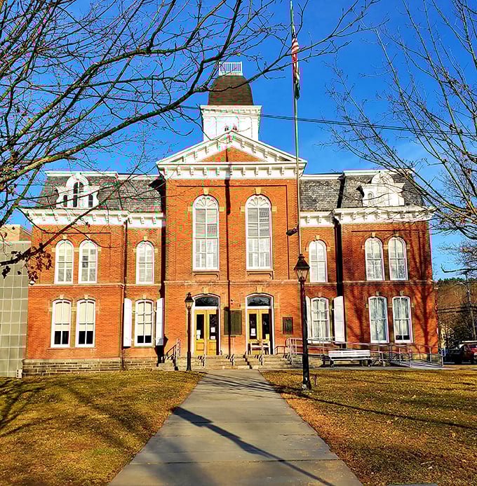 The Pike County Courthouse basks in golden hour light, its brick façade and white trim a testament to civic architecture that actually makes you feel patriotic.