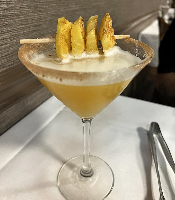 Not all tropical vacations require a passport—sometimes they arrive in a martini glass with grilled pineapple perched on the rim.