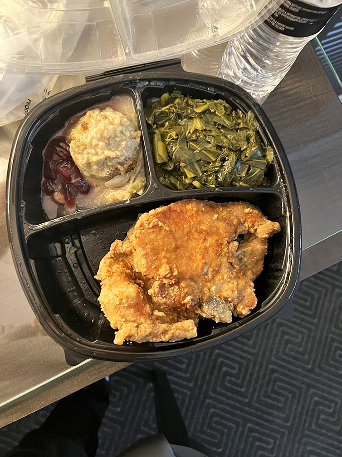 Collard greens and mac and cheese flanking fried perfection—the holy trinity of soul food sides. A balanced meal by Southern standards. 