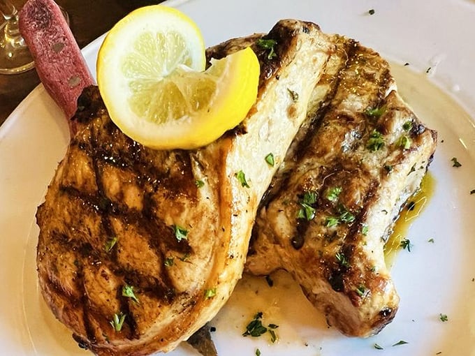 Grilled pork chops with a perfect char mark pattern that would make a geometry teacher proud. The lemon wedge isn't just garnish—it's essential flavor architecture.