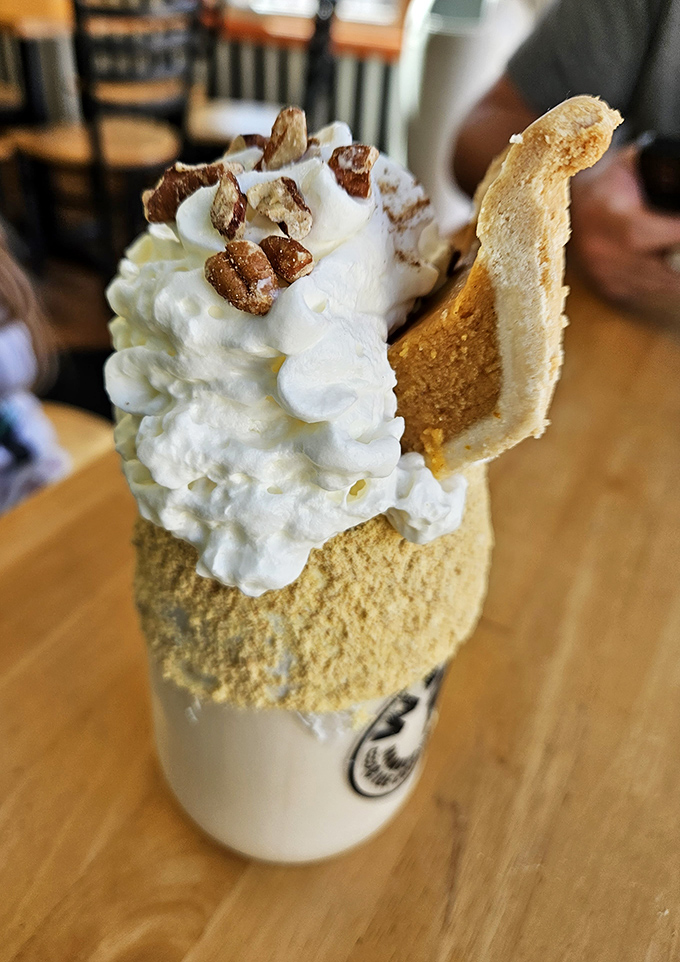 This isn't just a shake—it's autumn in a cup with a crown of whipped cream and what appears to be candied pecans for good measure.