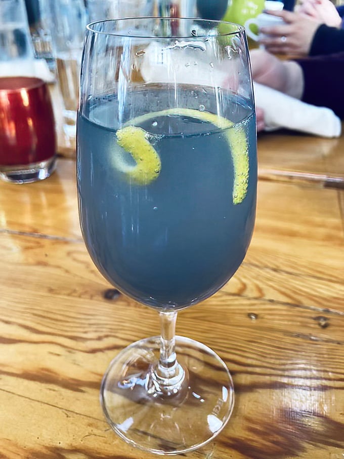 This blue cocktail isn't having an identity crisis—it's confidently making the case that drinks should be as photogenic as the view.