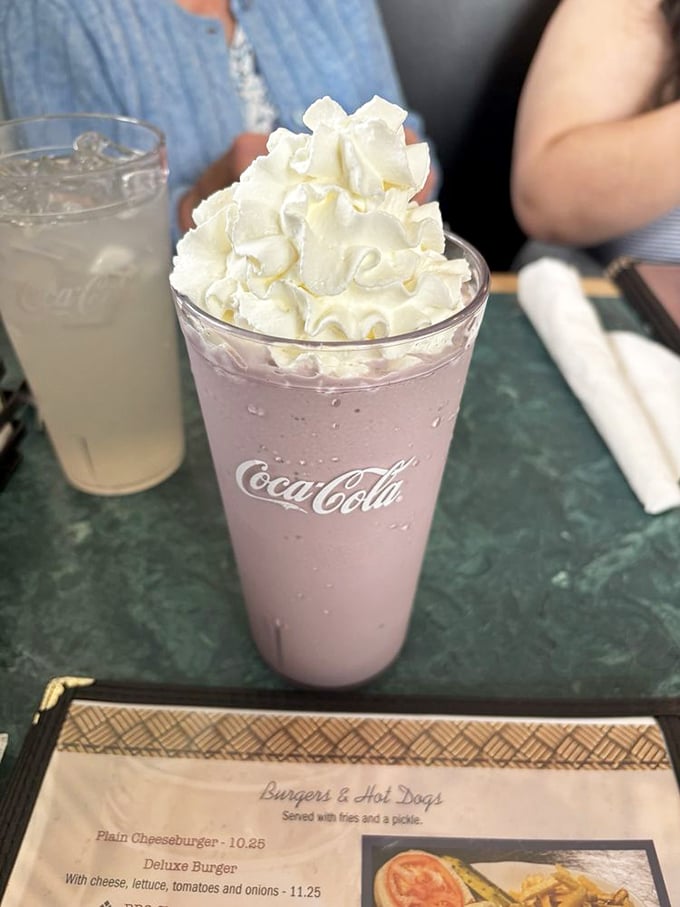 This raspberry milkshake isn't just a drink, it's dessert with a straw—crowned with whipped cream and served in a glass that takes you back to simpler times.