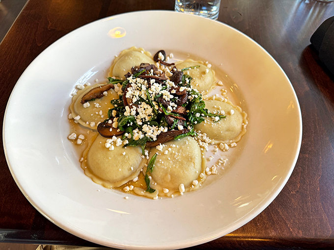 Pillowy ravioli swimming in a golden broth, topped with fresh herbs and cheese—proof that simplicity often delivers the most profound flavors.