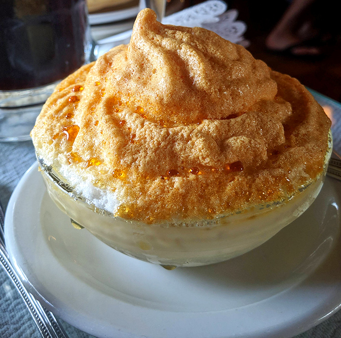 This isn't just dessert—it's a cloud of meringue floating atop what might be the most comforting custard this side of Munich.