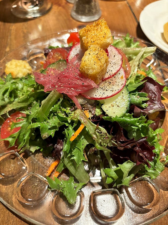A garden party on a plate where every vegetable and crouton seems dressed for a special occasion.