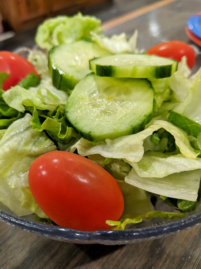 Even the house salad shows care—crisp vegetables offering a refreshing counterpoint to the parade of fried delights to come.