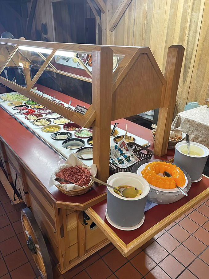 The salad bar wagon—ingeniously designed with Amish craftsmanship—offers fresh respite before the inevitable second trip to the hot buffet line. 