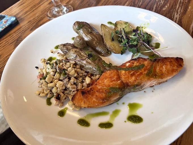 Salmon that's achieved that elusive perfect sear—like getting a suntan without the burn, accompanied by nature's confetti of vegetables.