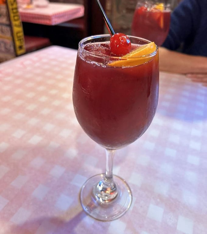 Sangria that looks like liquid sunset in a glass. The fruit isn't garnish—it's taking a well-deserved spa day.