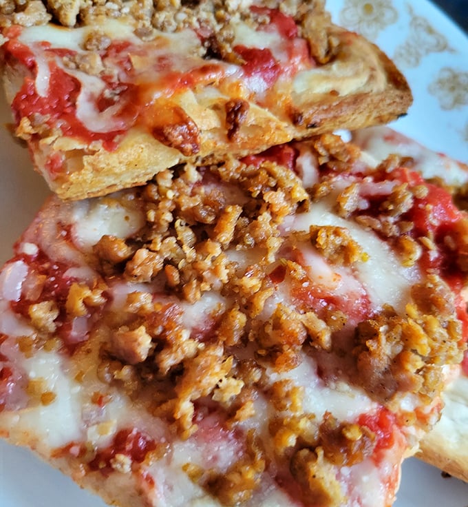 Sausage pizza done right – where each bite delivers that perfect marriage of spicy meat, tangy sauce, and cheese that stretches for days.