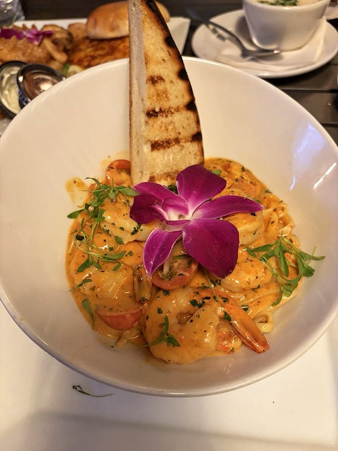 Sautéed shrimp in a sunset-colored sauce, garnished with an edible purple flower—proof that sometimes the most beautiful art in Panama City isn't hanging in galleries.