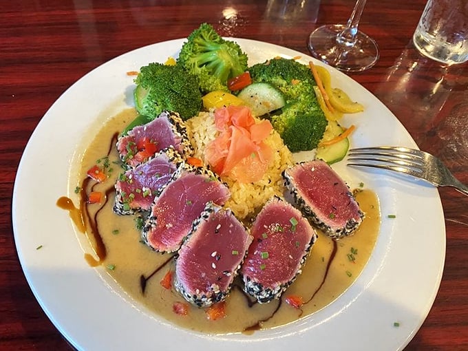 Sesame-crusted tuna that's perfectly seared on the outside, ruby-red within, surrounded by a colorful landscape of vegetables and rice—edible art that tastes even better than it looks.