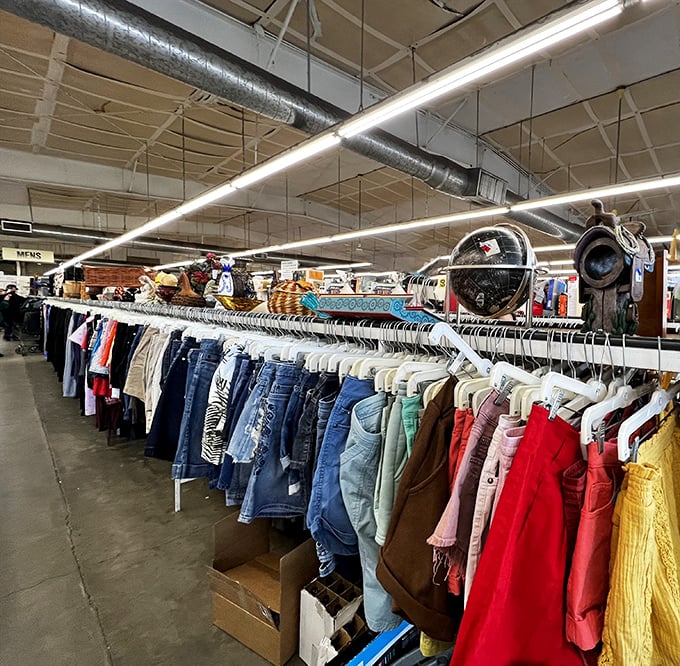 The clothing section stretches into infinity, a rainbow road of fashion possibilities where yesterday's trends become tomorrow's vintage finds.