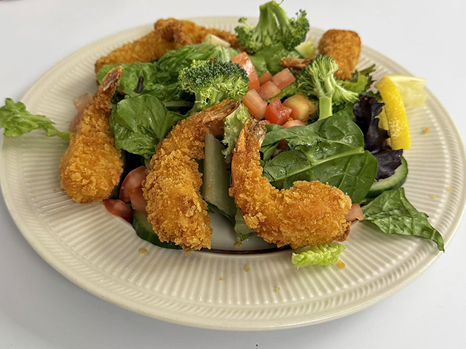 Even salads get the royal treatment here – crispy golden shrimp perched atop fresh greens proves that "diner food" and "light option" aren't mutually exclusive concepts.