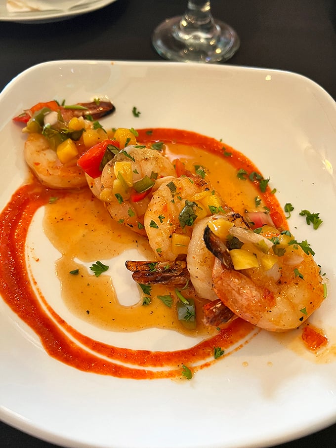 Shrimp so perfectly cooked they practically snap when bitten, adorned with a colorful mango salsa that's both tropical vacation and culinary achievement.